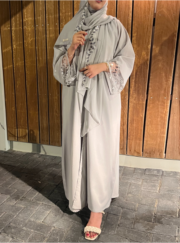 Grey Abaya Grey abaya adorned with embellished sleeve trimmings. Comes with a matching headscarf ...
