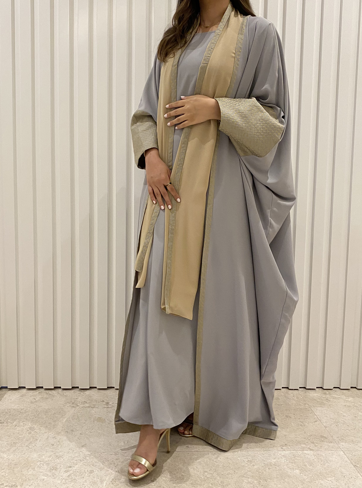 Grey Abaya 03 Light grey abaya with contrast patterned trimmings. Comes with a matching ...