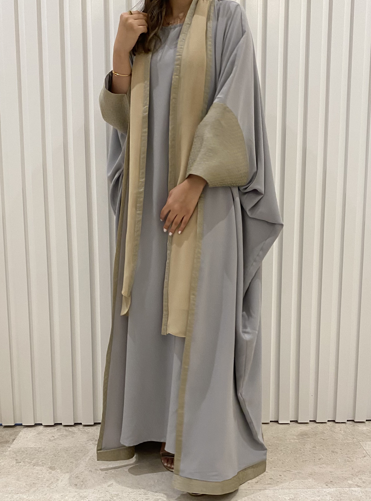 Grey Abaya 03 Light grey abaya with contrast patterned trimmings. Comes with a matching ...