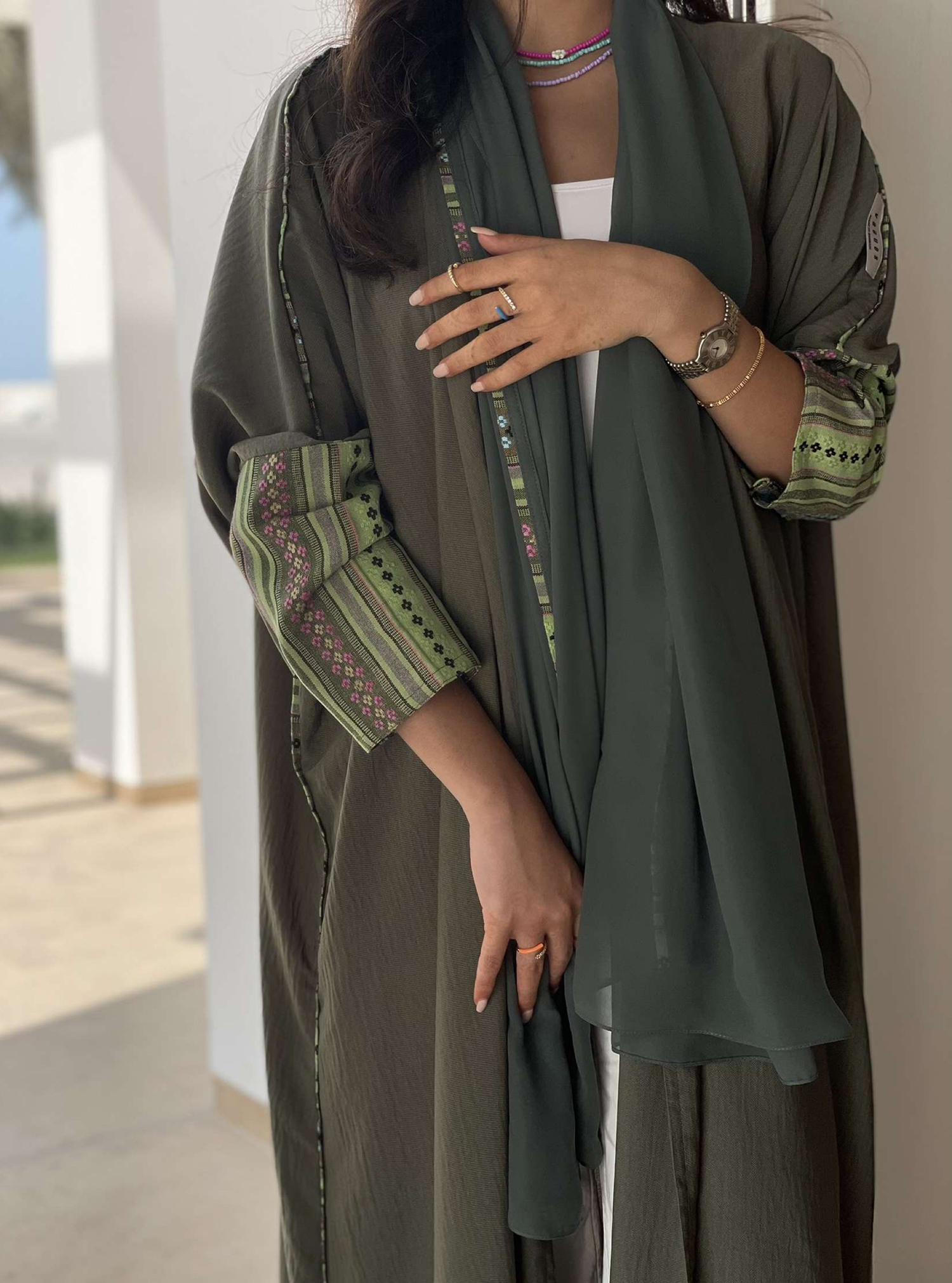 Jasmin green Subdued green abaya with patterned sleeves and trimmings ...