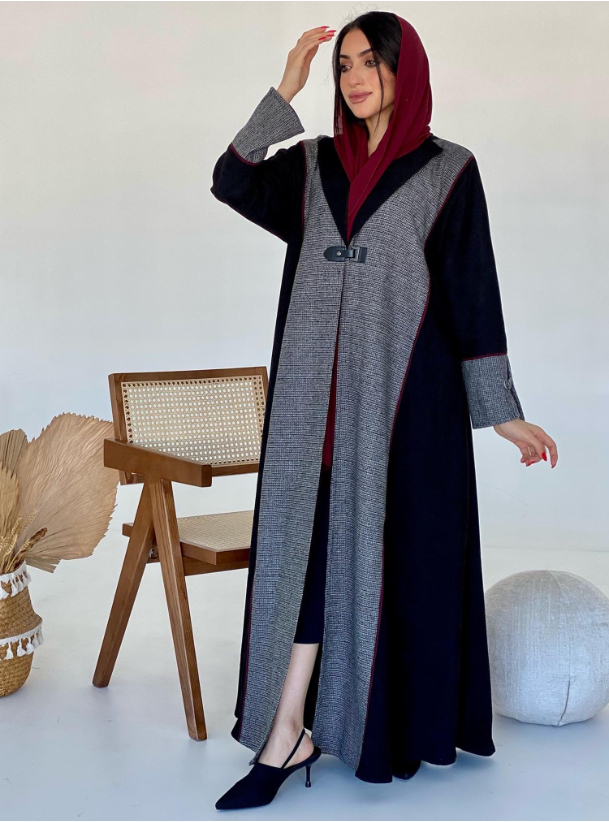 Winter abaya Black winter abaya with patterned trimmings and front buckle closure. Comes with a ...