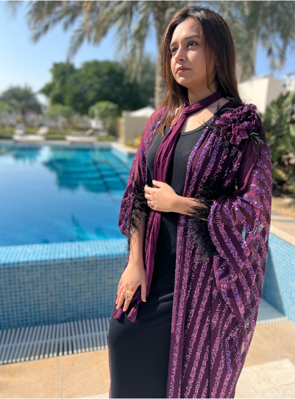 Bling purple Sequined purple abaya with flower brooch applique and feather trimmings. Abayas ...