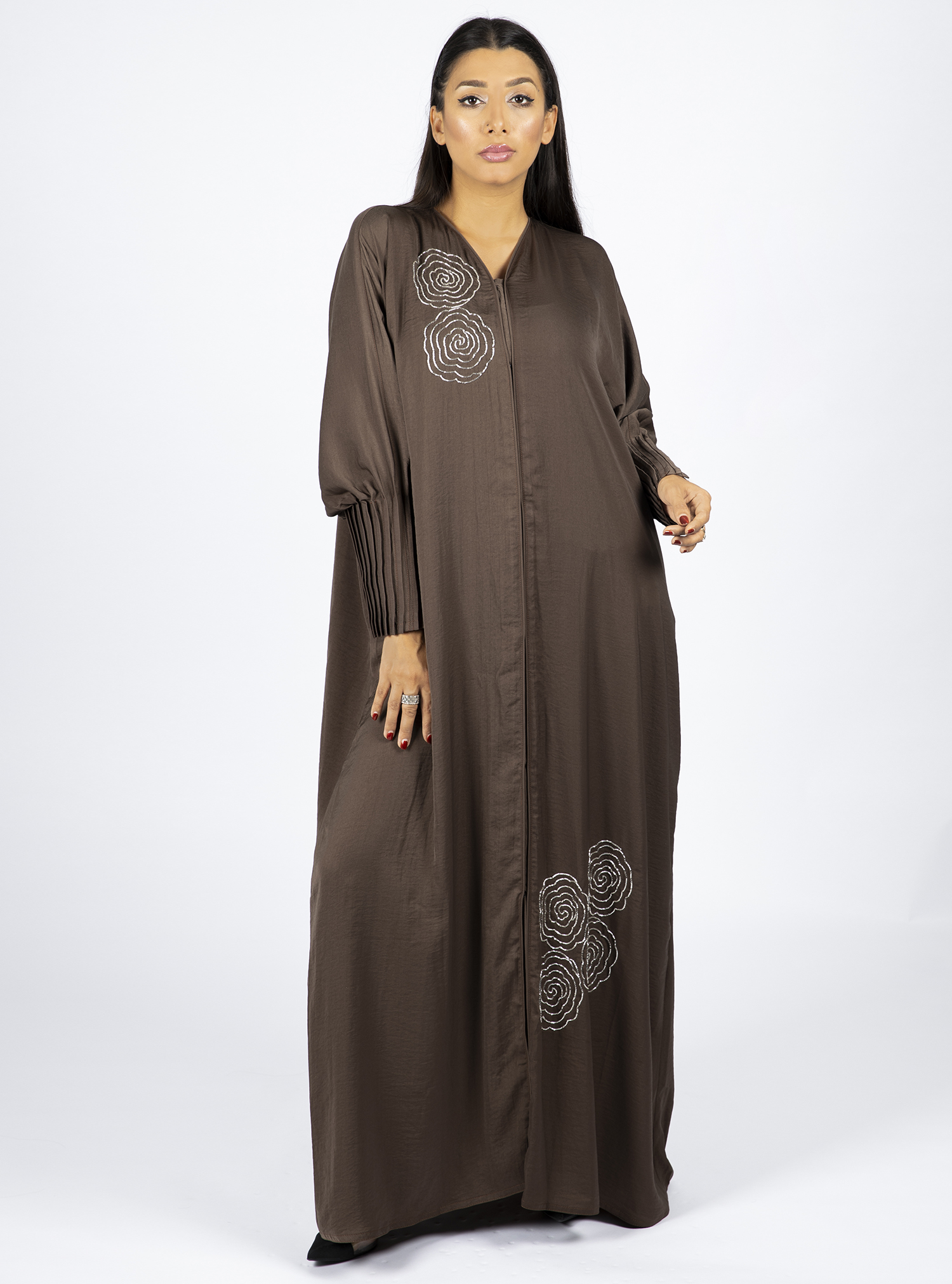 Brown Abaya A brown abaya with unique sleeves and embellishments combines traditional and modern ...