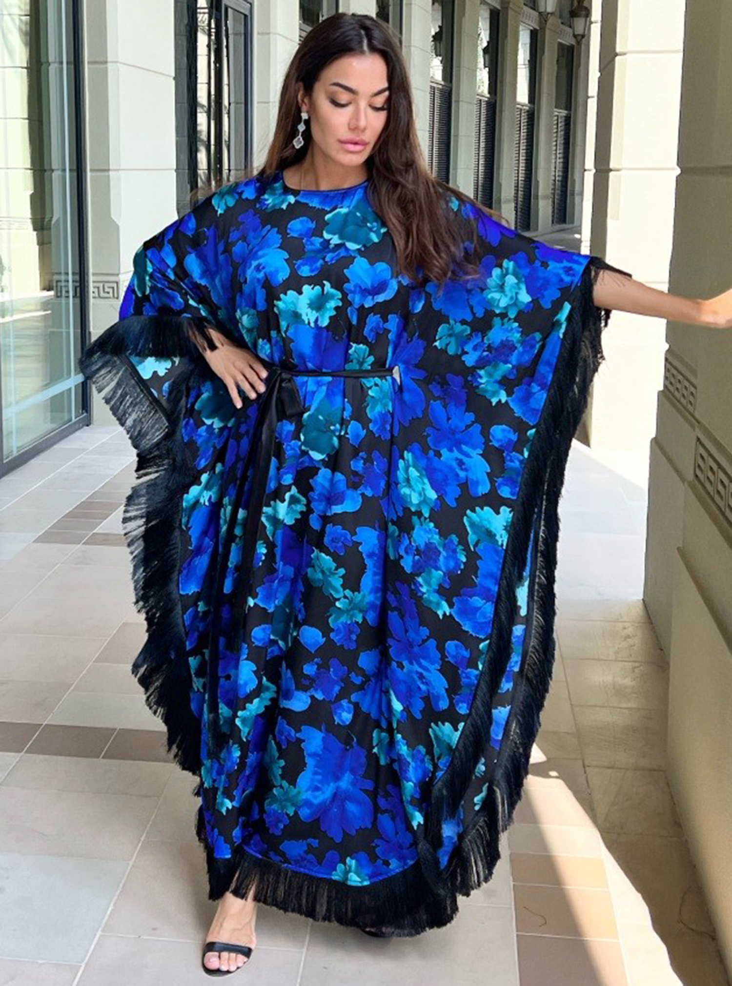 ROJA BLUE A luxurious silk kaftan adorned with delicate fringes and a ...