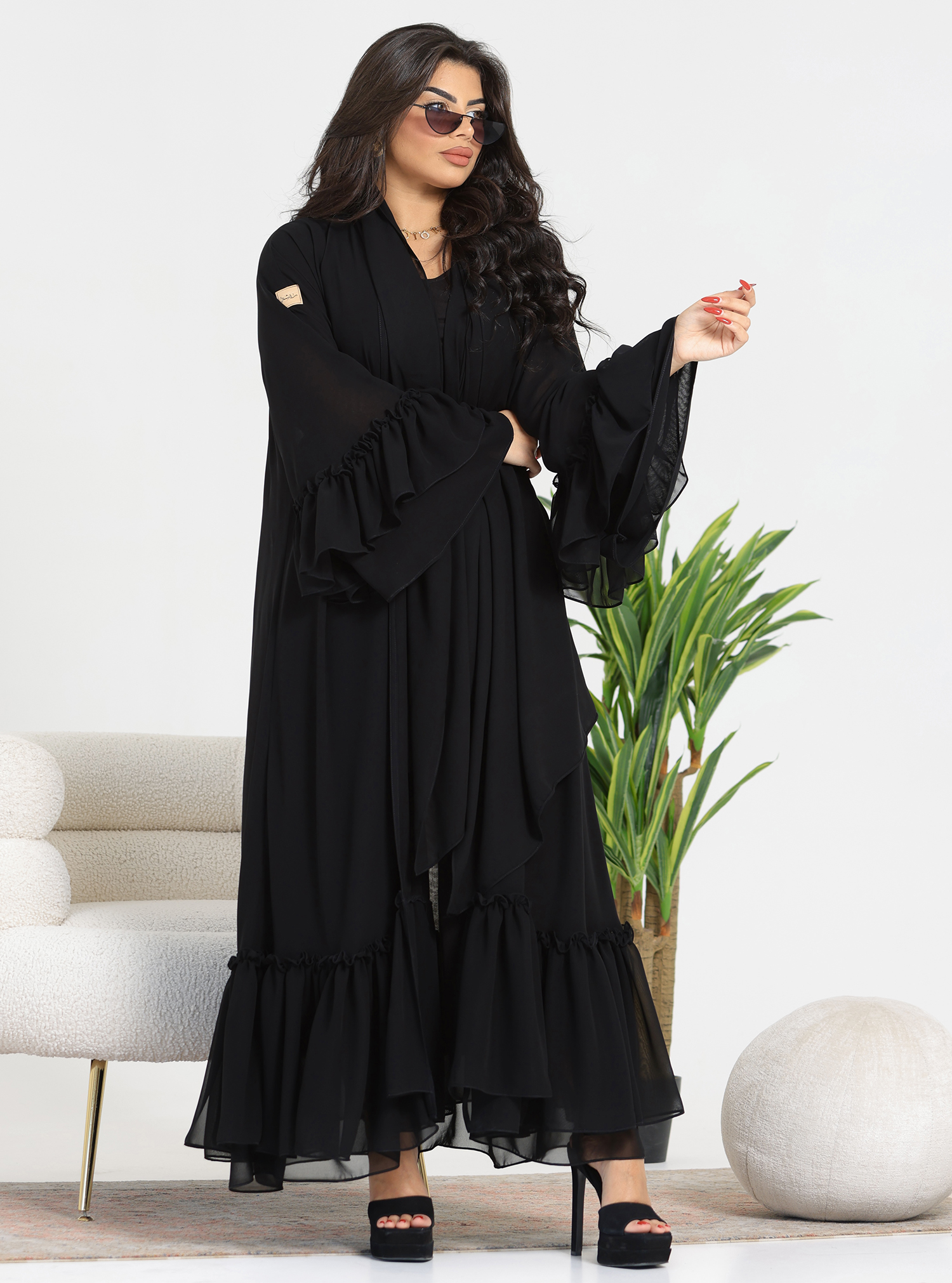 Ruffled Abaya A classic black abaya with ruffle trimmings. Comes with a ...