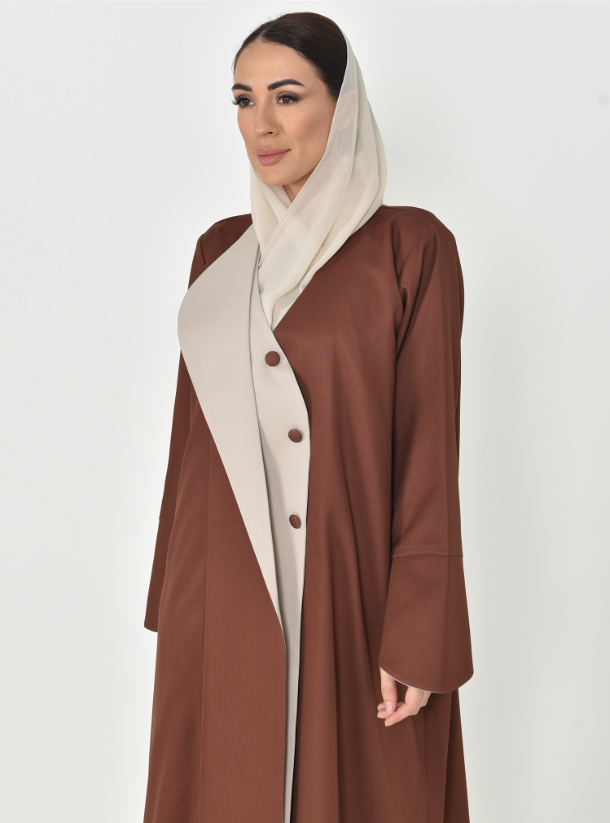 Contrast Abaya Brown abaya with buttons and asymmetrical collar. Abayas from 1609 SPACE at Boksha