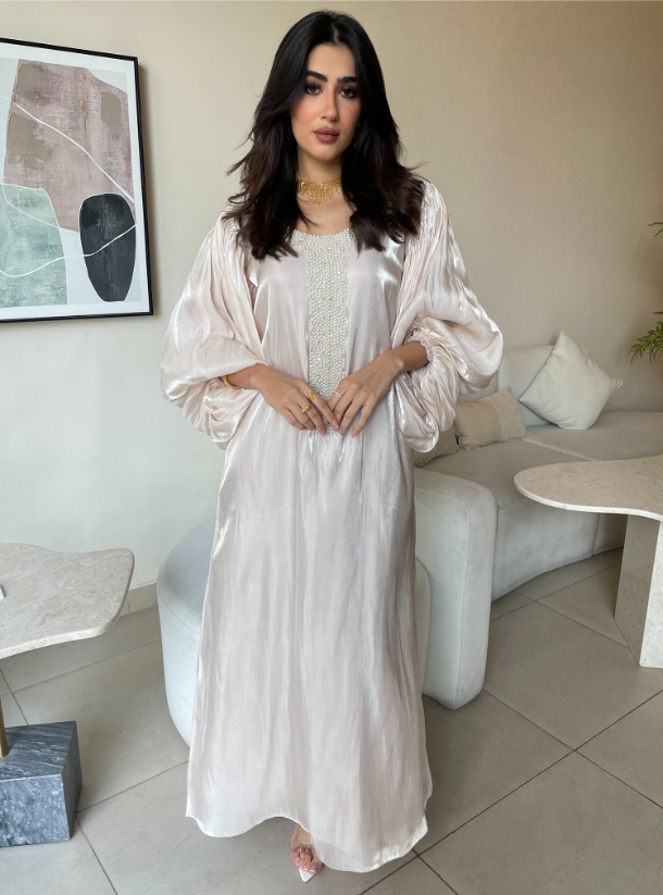 S102 Elegant cream dress adorned with crystals and pearls, featuring ...