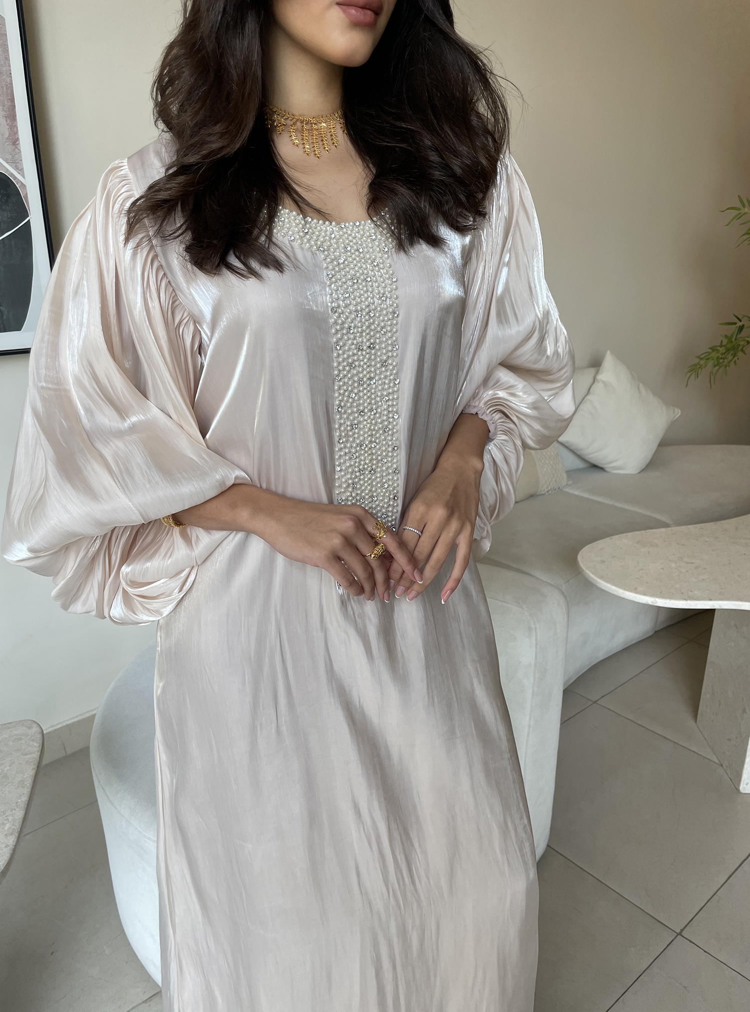 S102 Elegant cream dress adorned with crystals and pearls, featuring ...