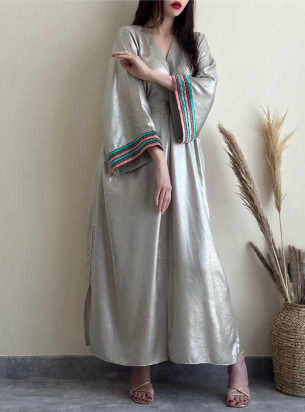 Shimmer kaftan Gold shimmer kaftan with V-neck and slits, decorated by ...